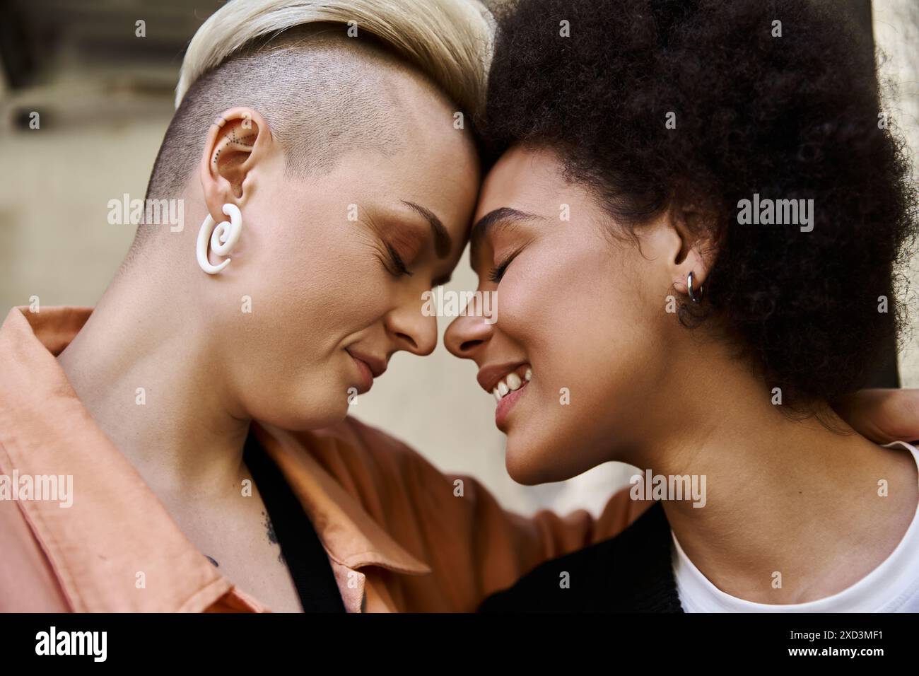 Two diverse, beautiful women standing close together in a cafe Stock ...