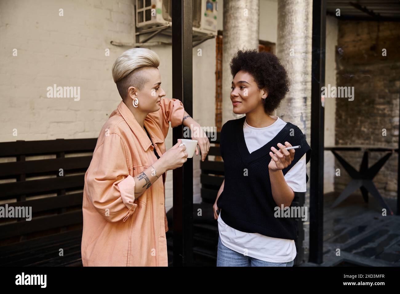 Two women elegantly engaged in conversation Stock Photo - Alamy