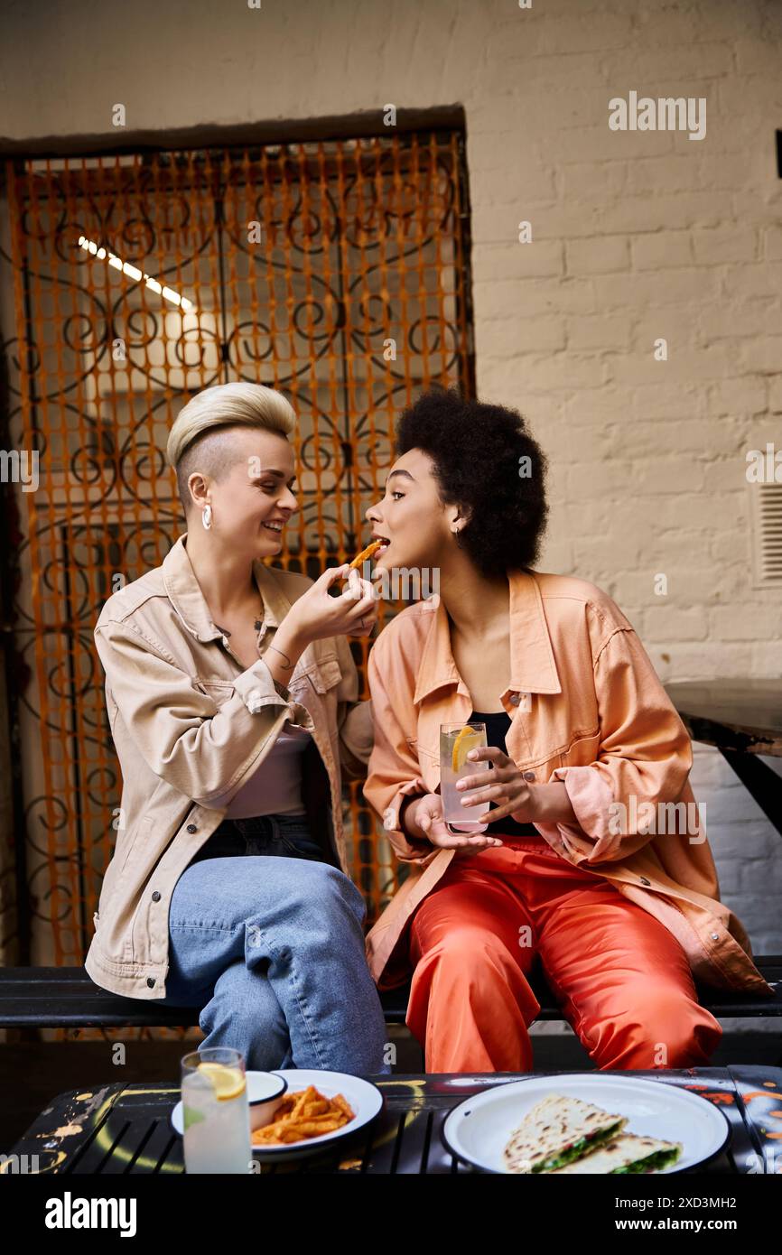 Two women seated together, engaged in lively conversation Stock Photo ...