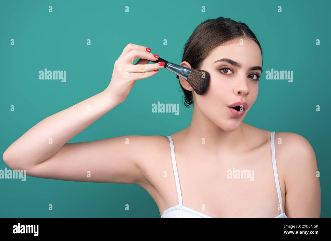 Woman hold blush blusher apply powder visage isolated over studio ...