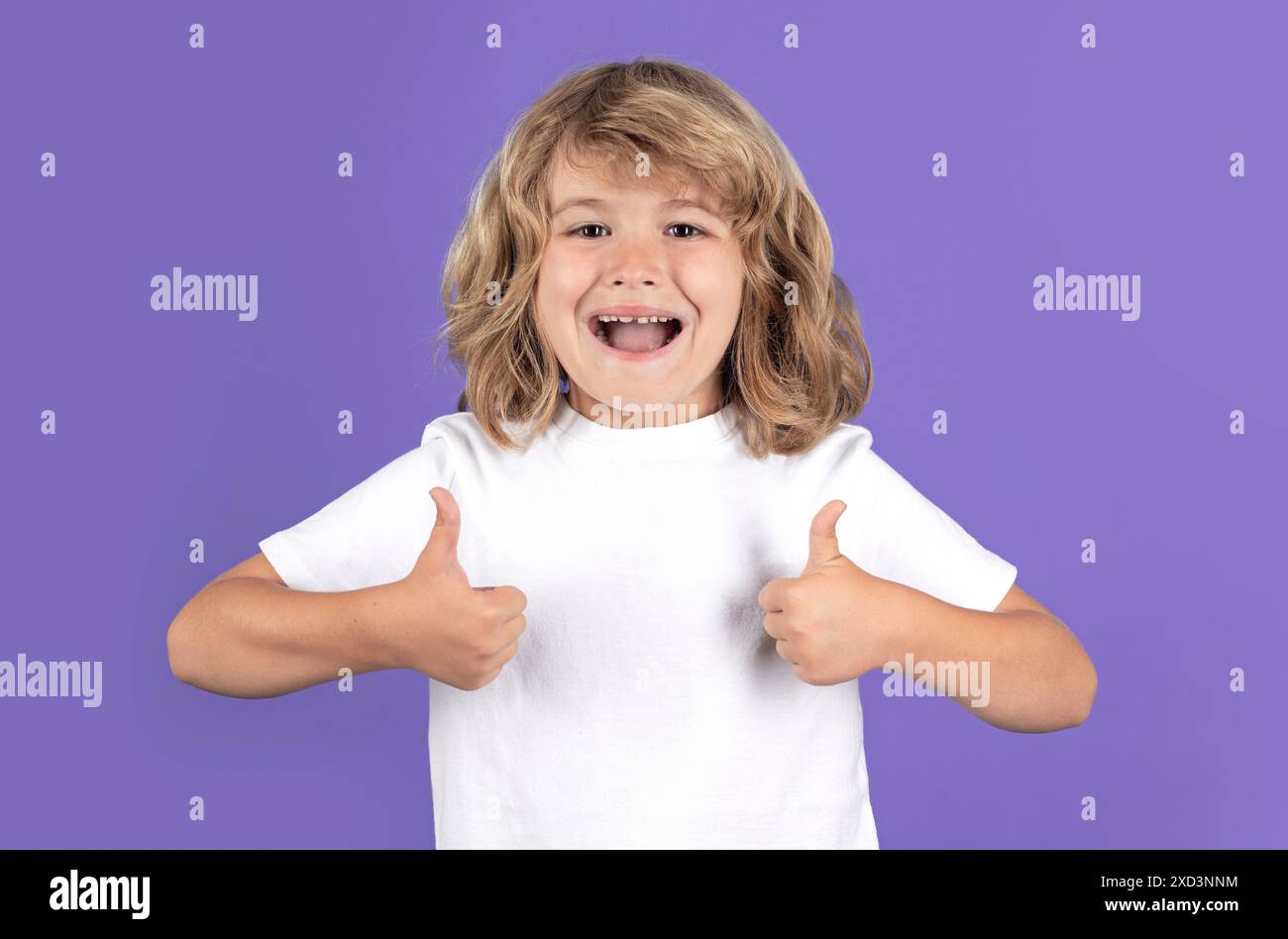 Excited kid boy with thumbs up on studio isolated background. Surprised ...