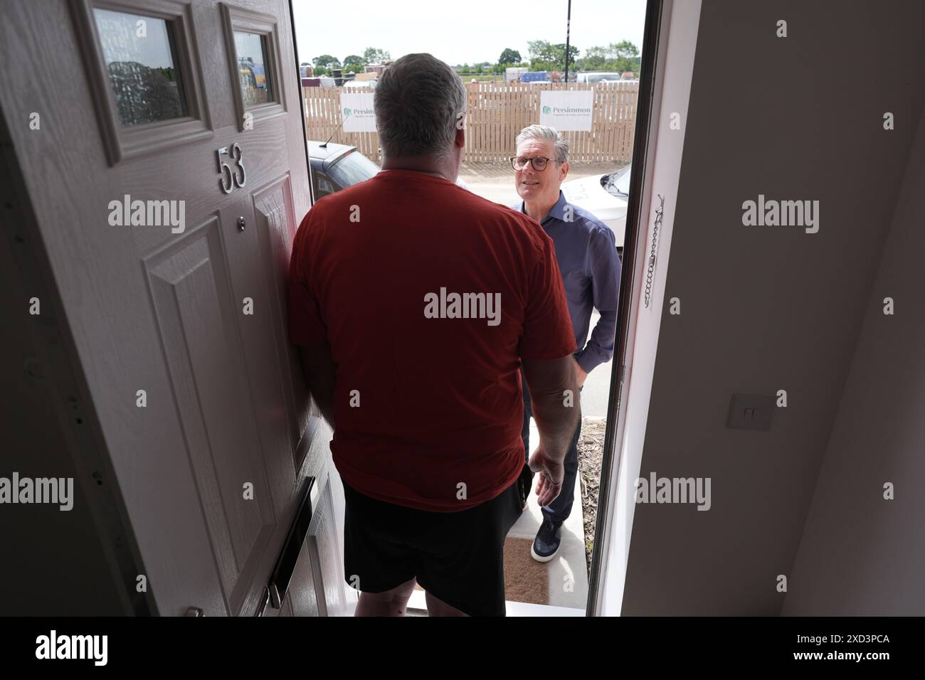 Labour leader Sir Keir Starmer talking to a resident during a visit to ...
