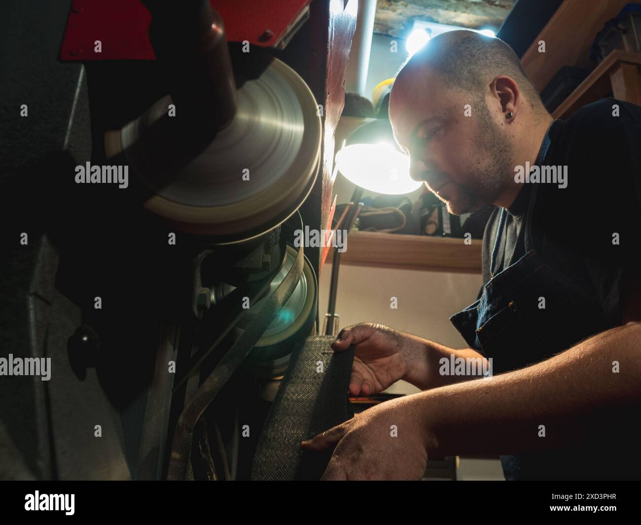 Shoemaker concentrating while working on repairing some shoes in the ...