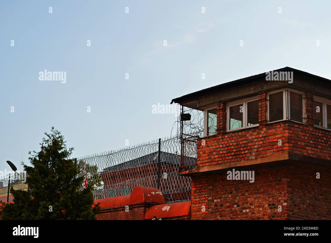 Prison tower and barbed wire fence Stock Photo - Alamy