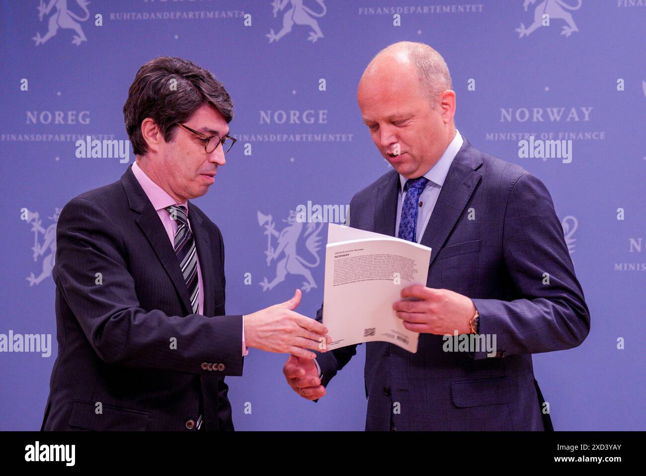 Oslo 20240620. OECD Director Luiz de Mello hands over the OECD's two ...