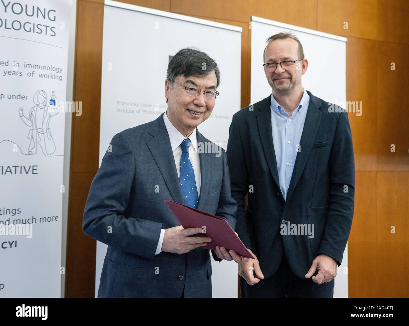Japanese scientist and immunologist Shimon Sakaguchi, left, receives ...