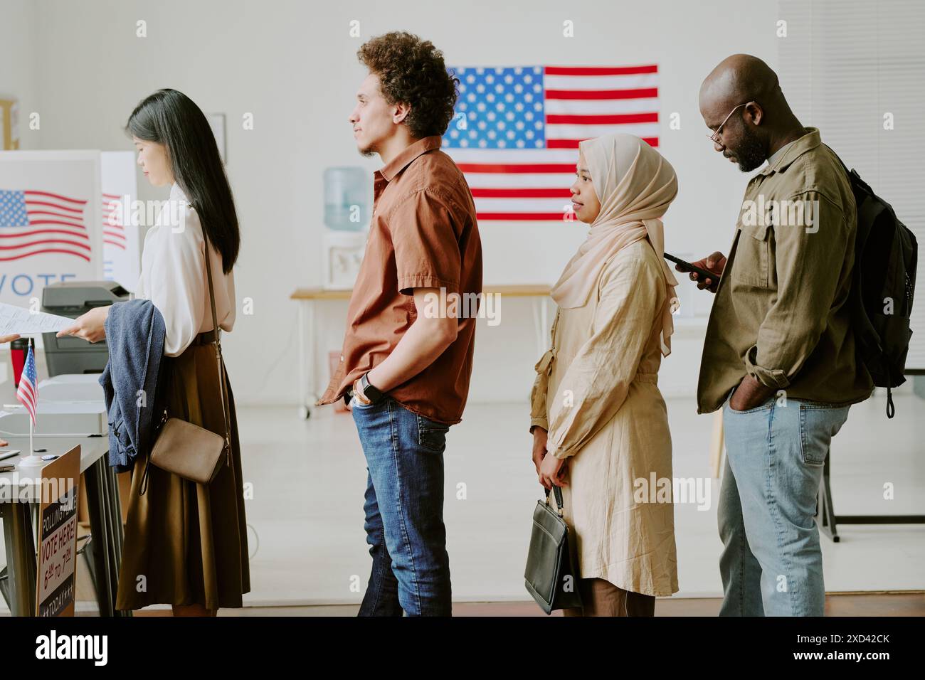 Medium long side view shot of ethnically diverse young people standing ...