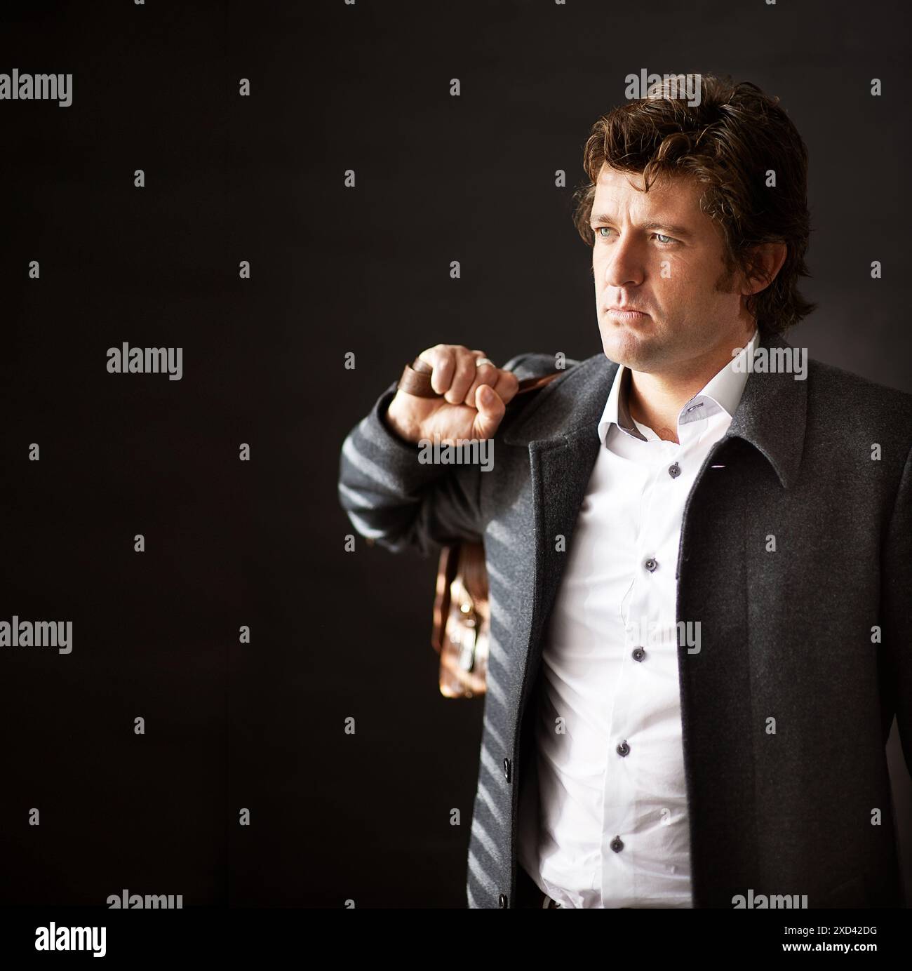 Thinking, travel and business man with leather bag for fashion on black ...