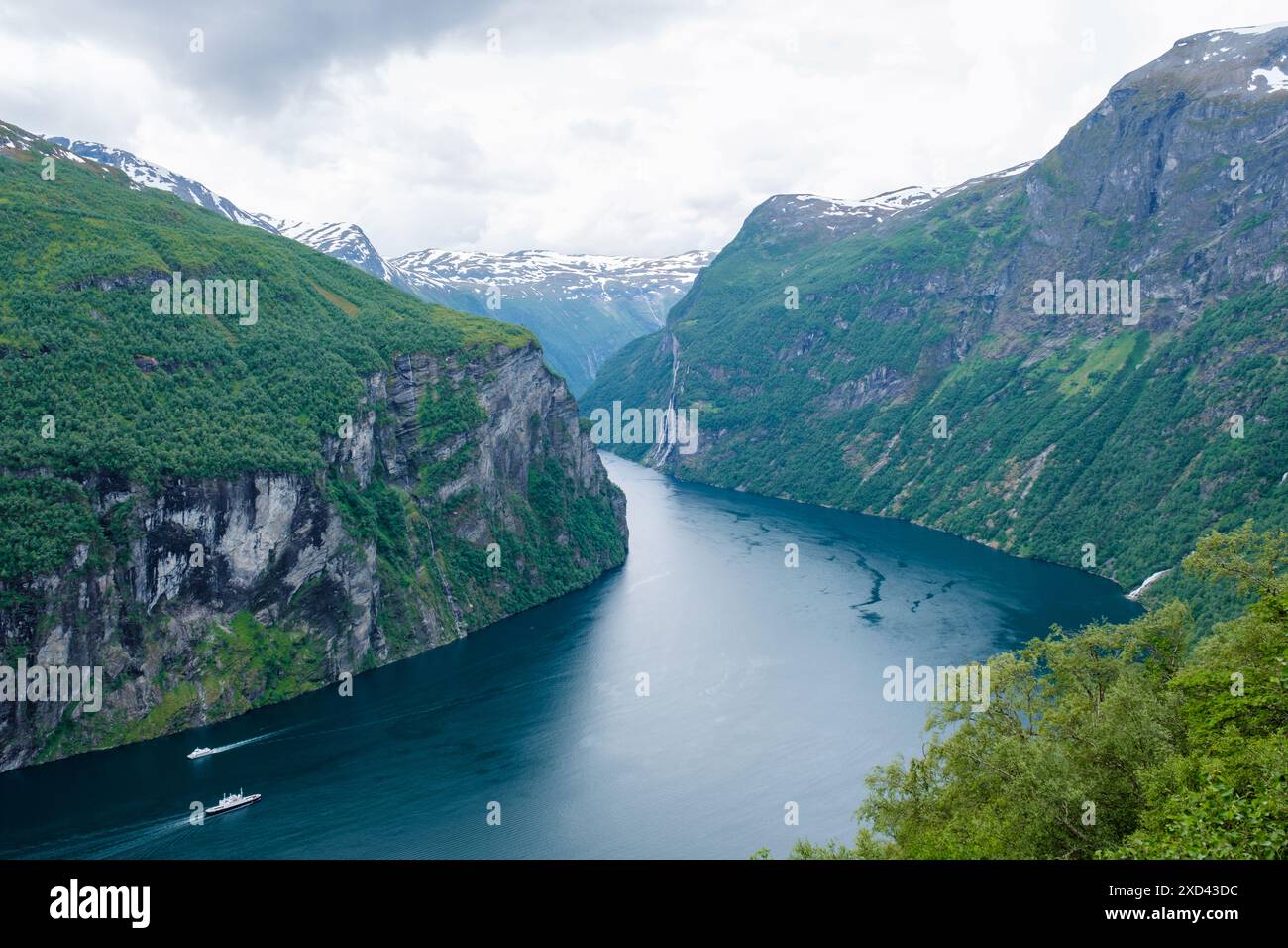 A breathtaking view of a Norwegian fjord surrounded by lush green ...