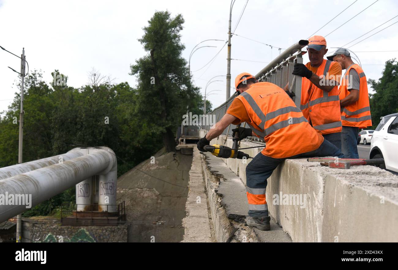 KYIV, UKRAINE - JUNE 20, 2024 - Workers repair the fragments of the ...