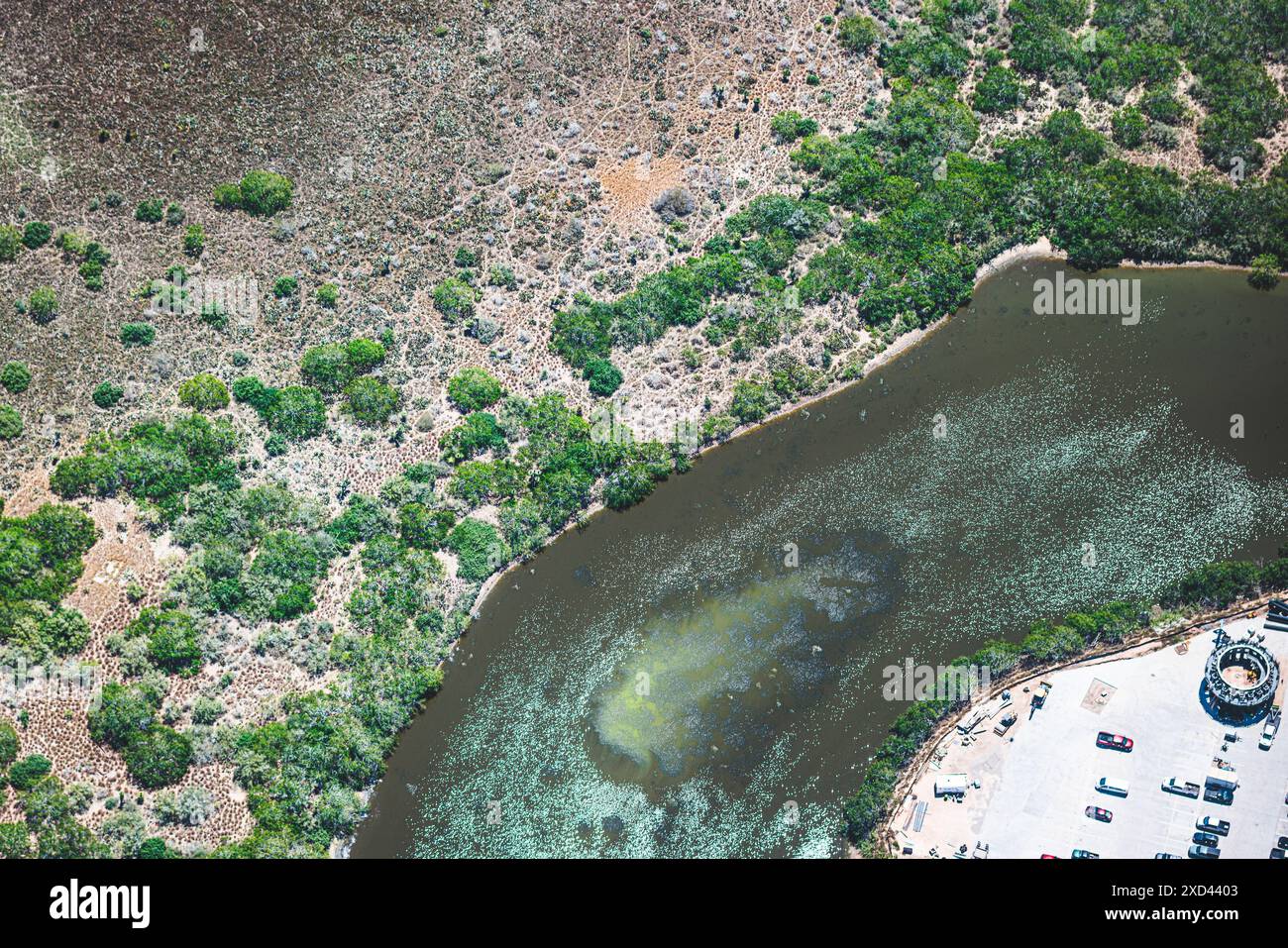 An aerial view of a river flowing through a landscape with sparse ...