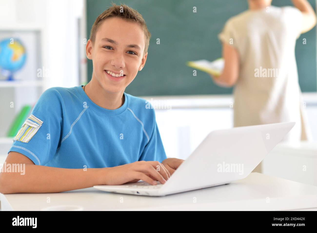 Portrait of boy studing with laptop at classroom Stock Photo - Alamy