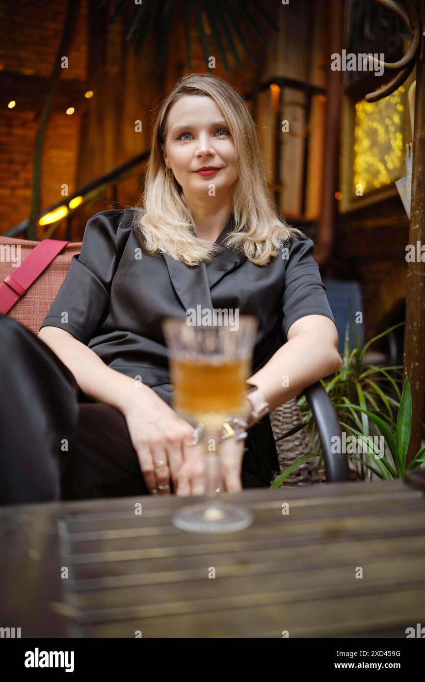 Middle aged woman enjoying her vacation while sitting on the terrace of ...