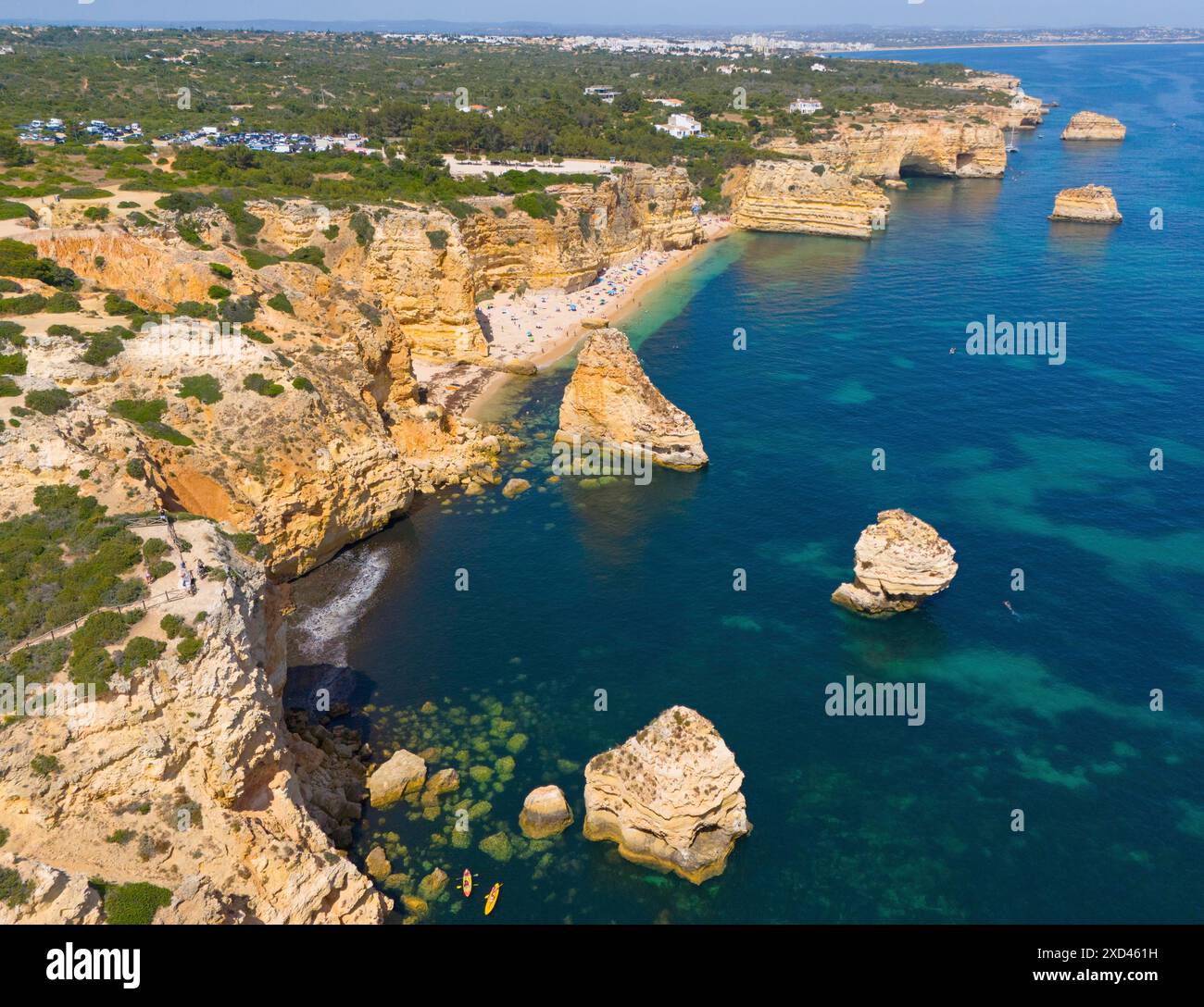 Steep cliffs and clear blue waters along the impressive coastline with ...