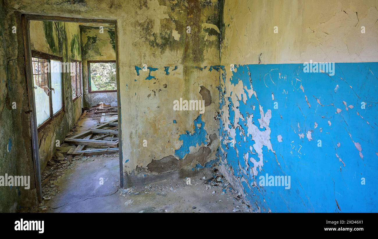 Dilapidated blue walls and windows in an abandoned building showing ...