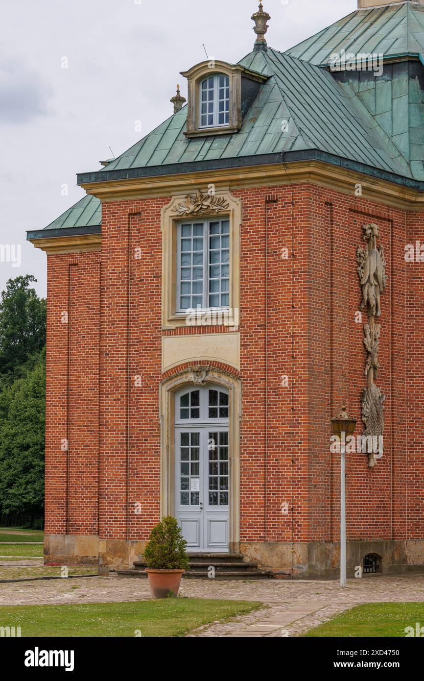 Close-up of part of a historic building with brick walls and green roof ...