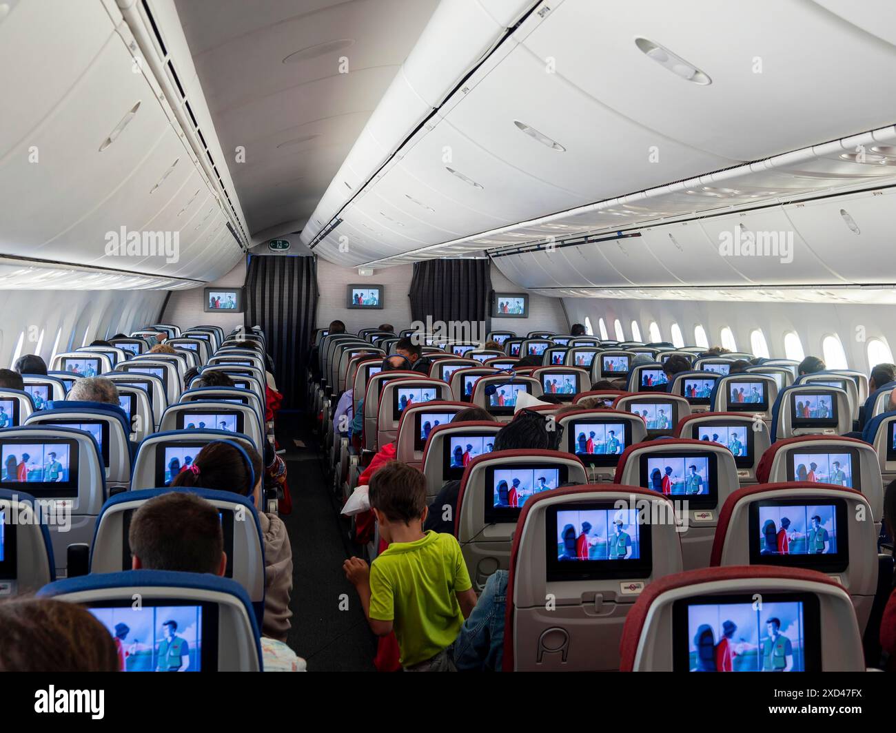 Aircraft interior, cabin with rows of seats and screens, Dreamliner ...