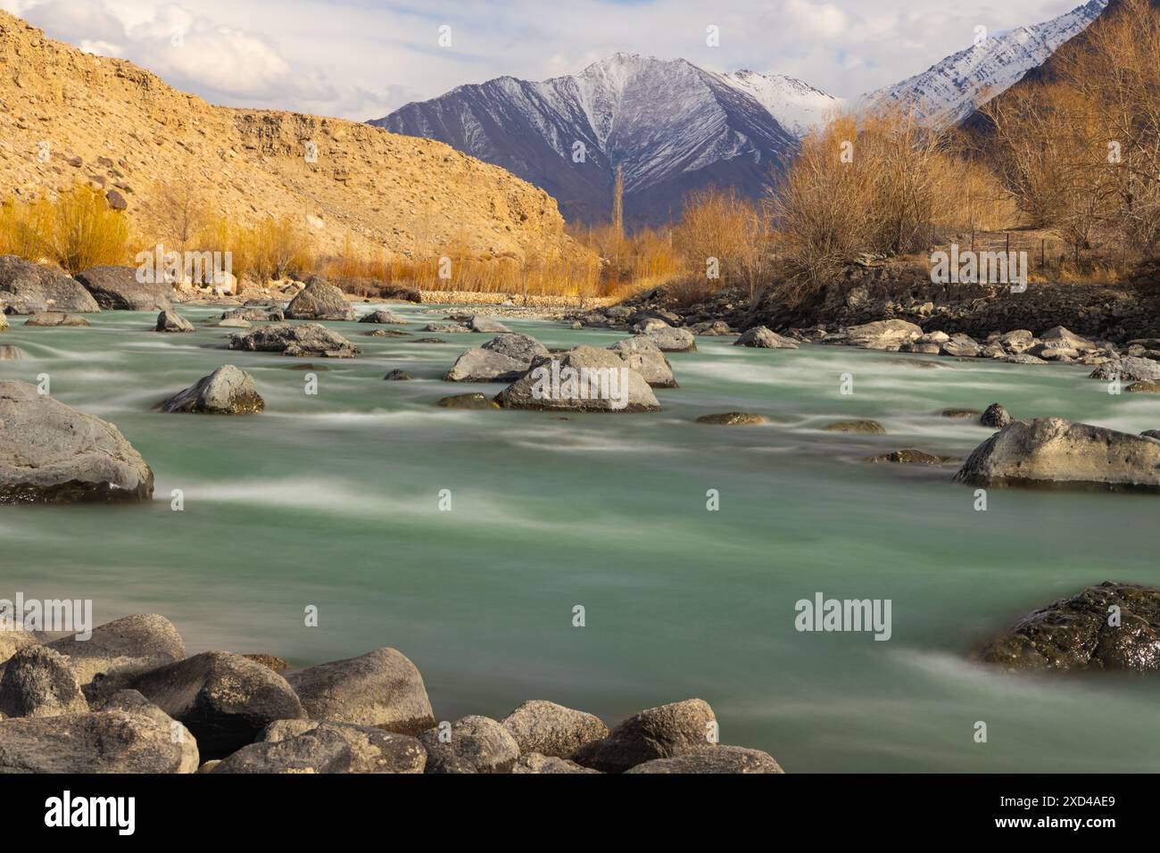 A beautiful landscape of Indus River flowing with rocks in the middle ...