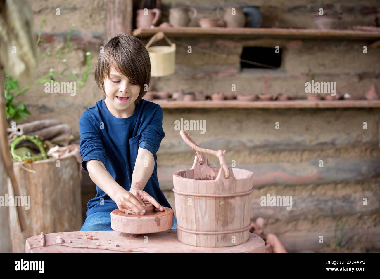 Child, cute boy, making ceramic pot on a farm Stock Photo - Alamy