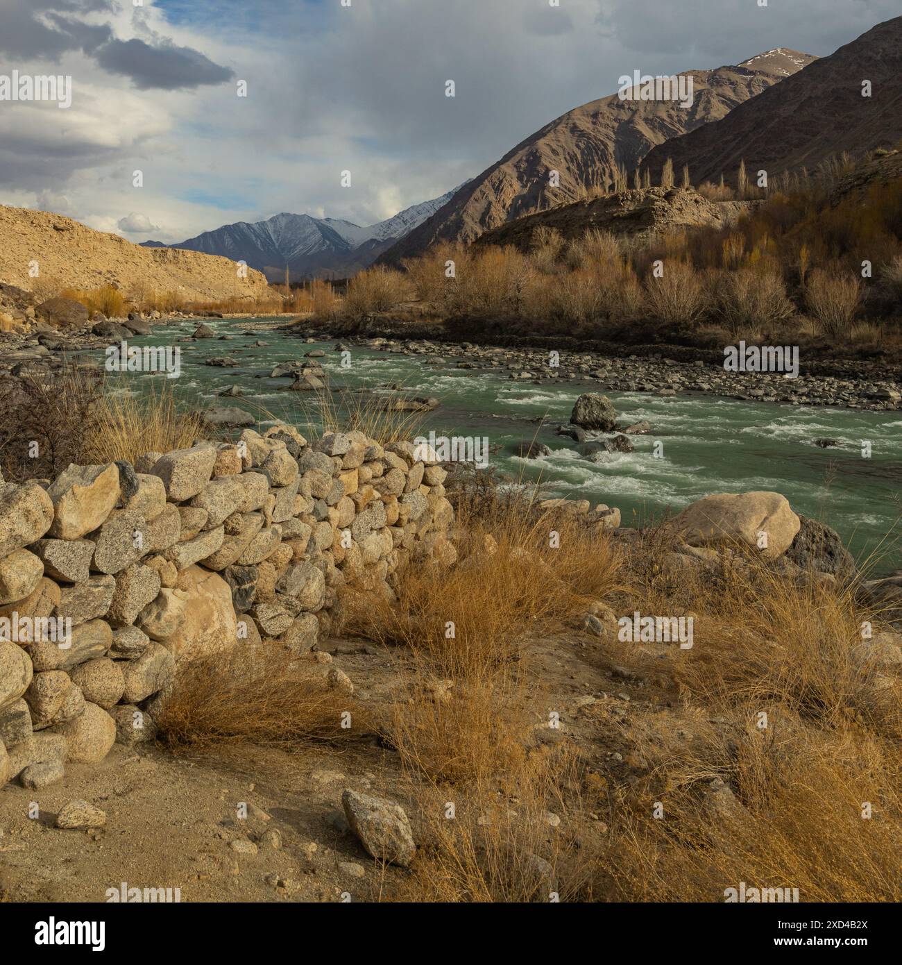 Clear blue water of Indus River flowing in between high-altitude ...