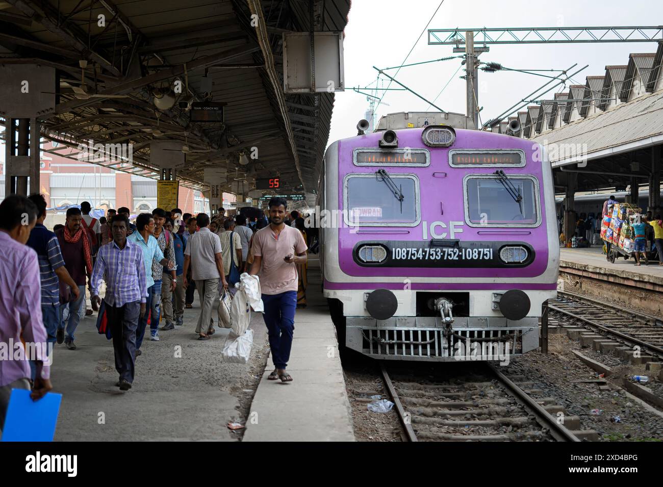 A local train stationed at the Howrah Junction Railway Station, part of ...