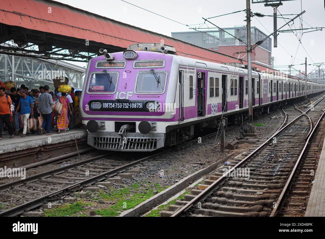 A local train stationed at the Howrah Junction Railway Station, part of ...