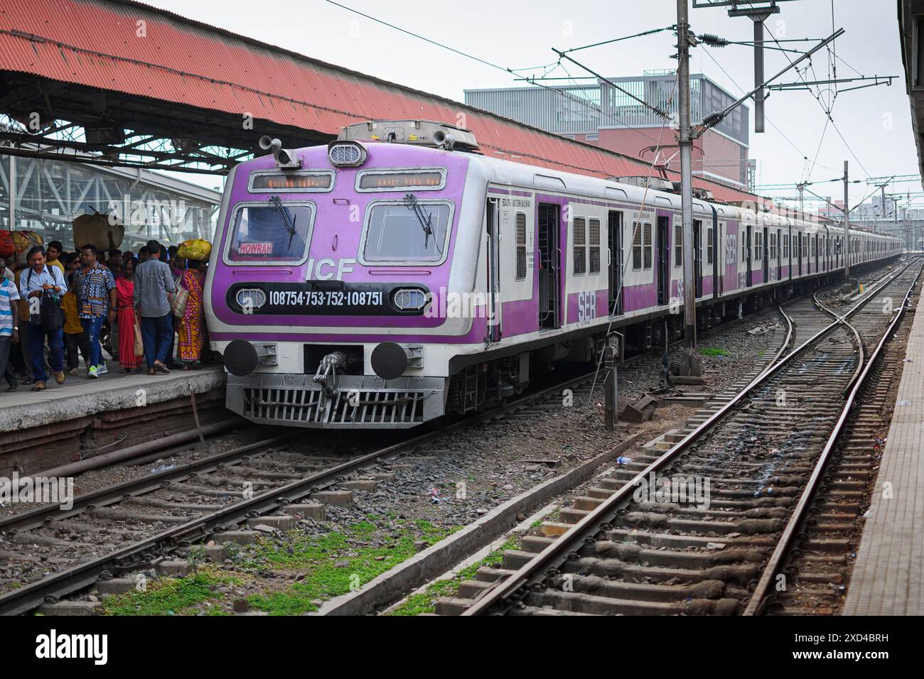 A local train stationed at the Howrah Junction Railway Station, part of ...