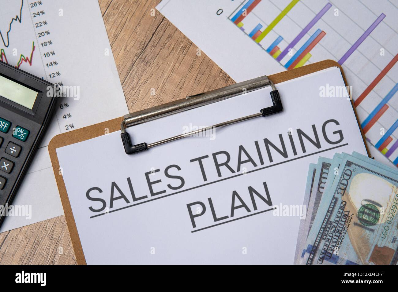 Top view image of a clipboard with the words SALES TRAINING PLAN ...