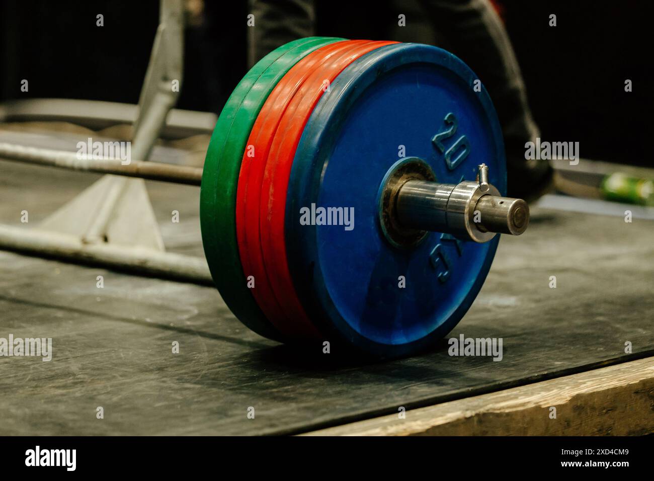 close-up barbell with red, green and blue plates on rubber floor Stock ...