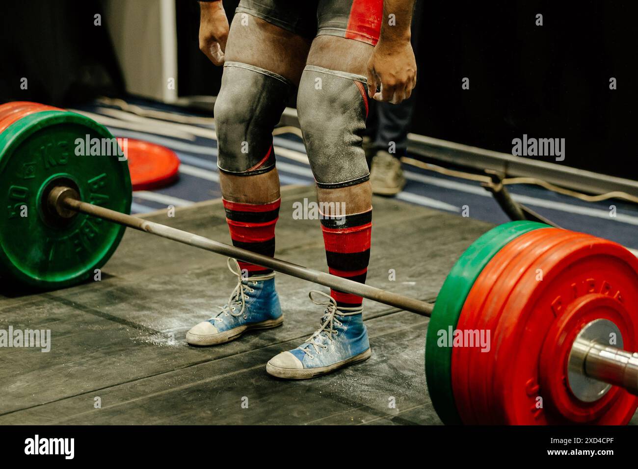 legs powerlifter in knee pads and sports talcum powder stand front ...