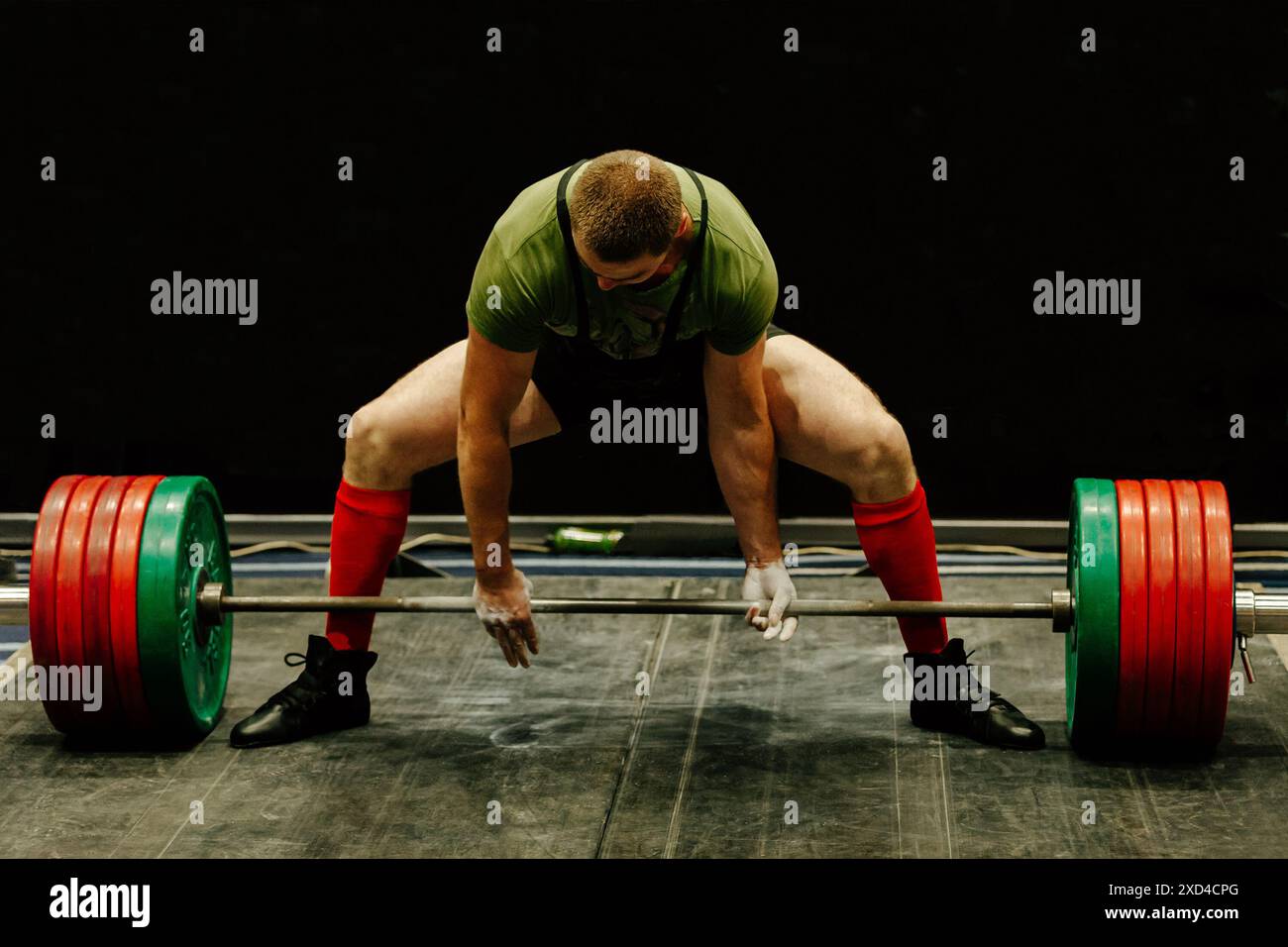 powerlift hold barbell with his hands, start attempt at deadlift ...