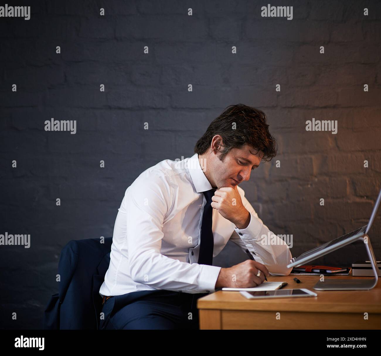 Desk, investigation and writing with detective man in office at night ...