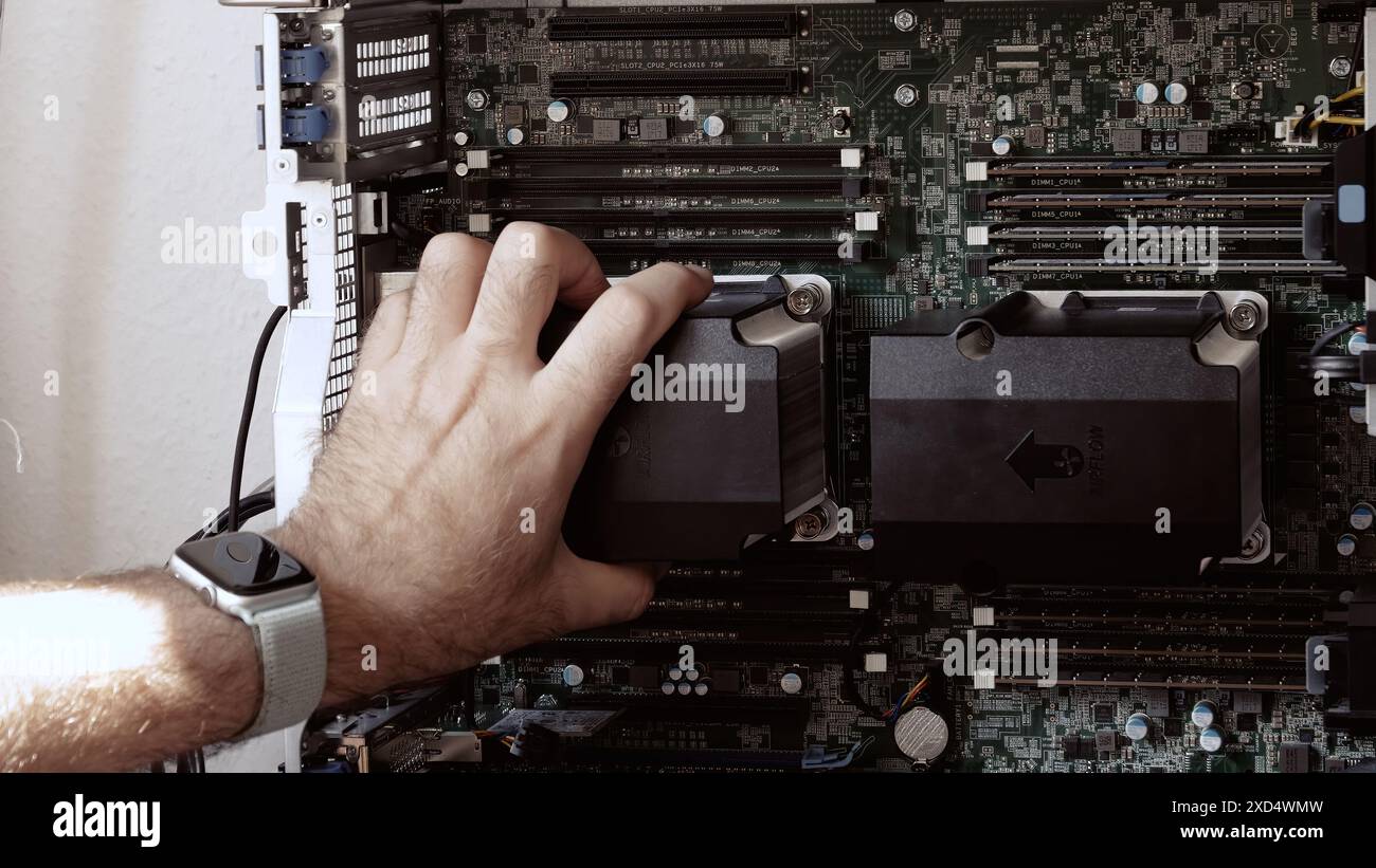 A man installing a second CPU in a powerful workstation for new AI and ...