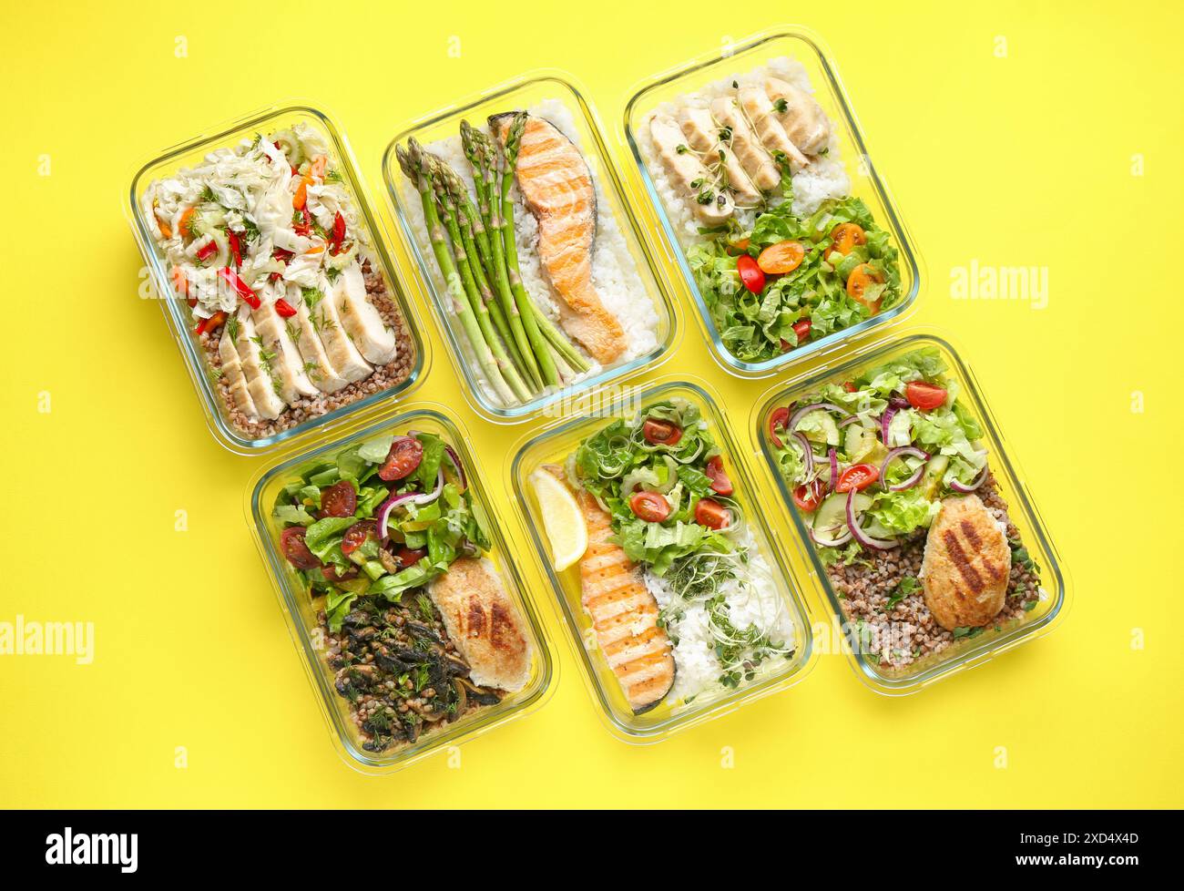 Healthy food. Different meals in glass containers on yellow background ...