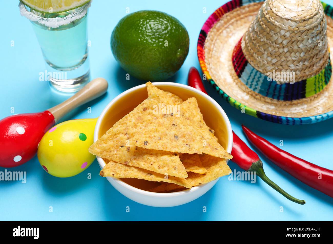 Mexican sombrero hat, nachos chips, maracas, tequila and chili pepper ...