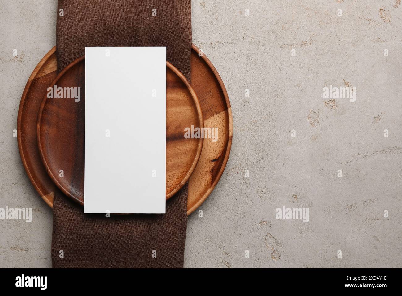 Empty menu and plates on light grey table, top view. Mockup for design ...