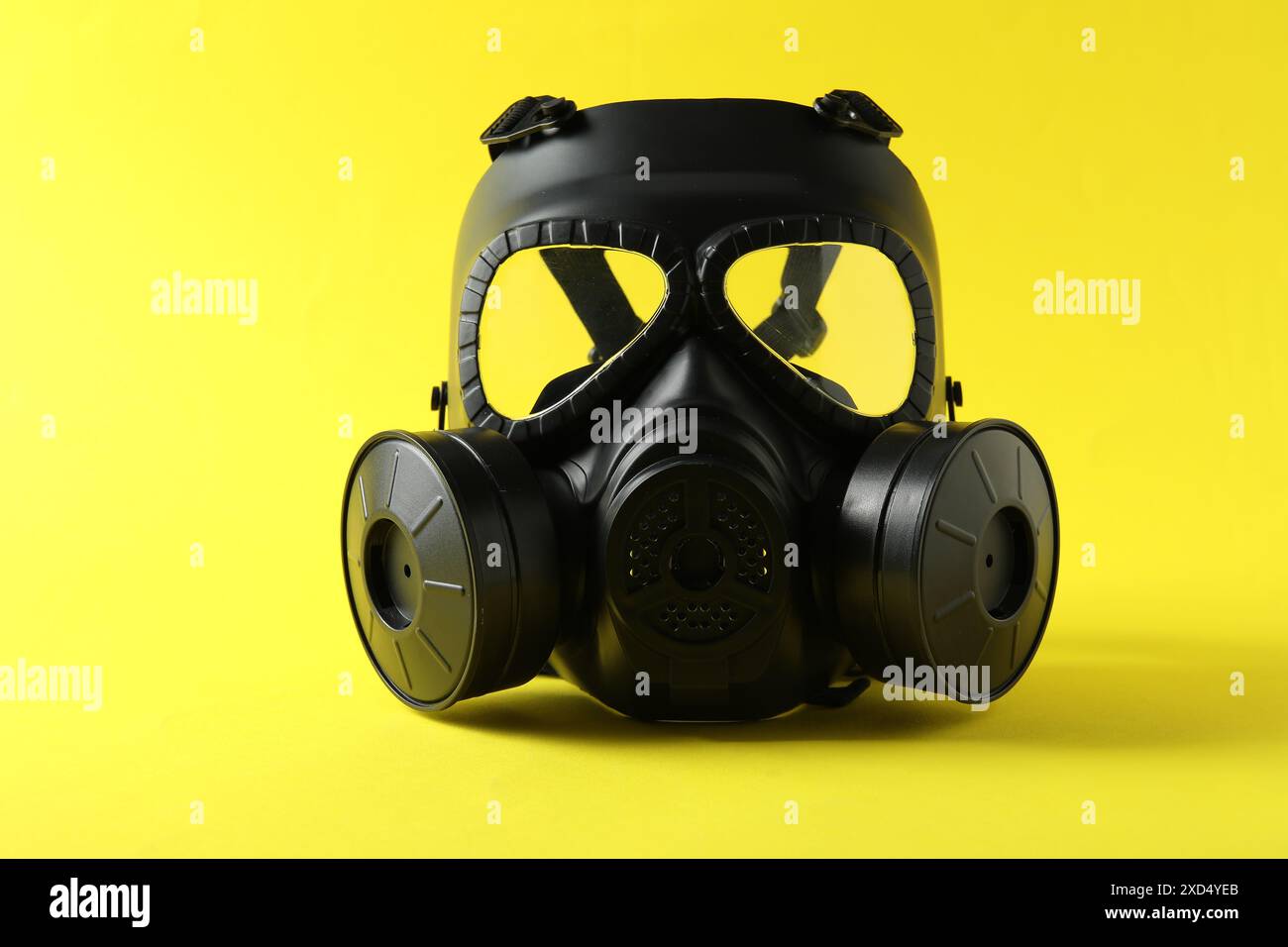 One gas mask on yellow background. Safety equipment Stock Photo - Alamy