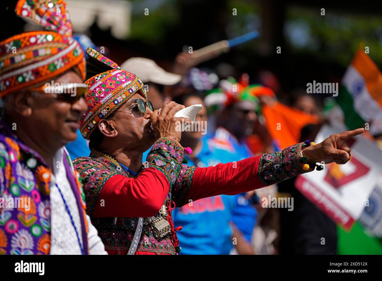 Indian supporters wearing traditional attire cheer for their team ahead ...