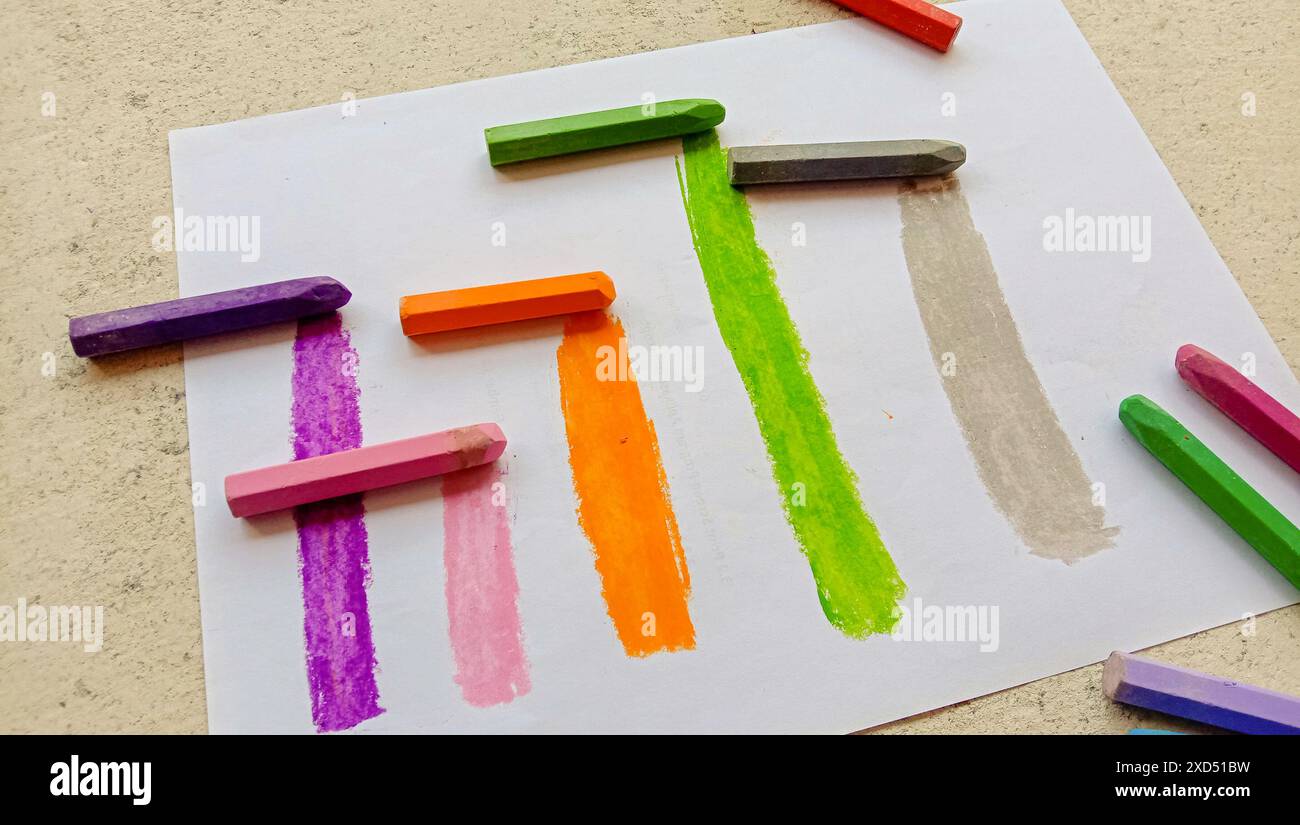 A paper with a combination of orange and yellow with crayon on the edge ...