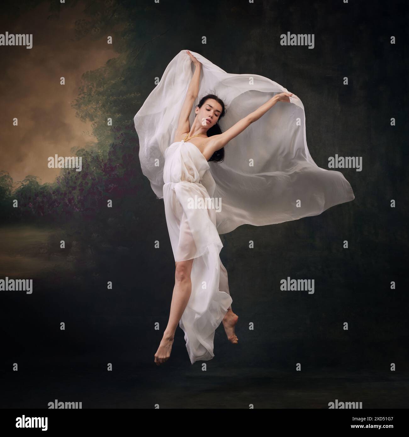 Elegant ballerina wrapped in sheer white fabric, suspended in timeless ...