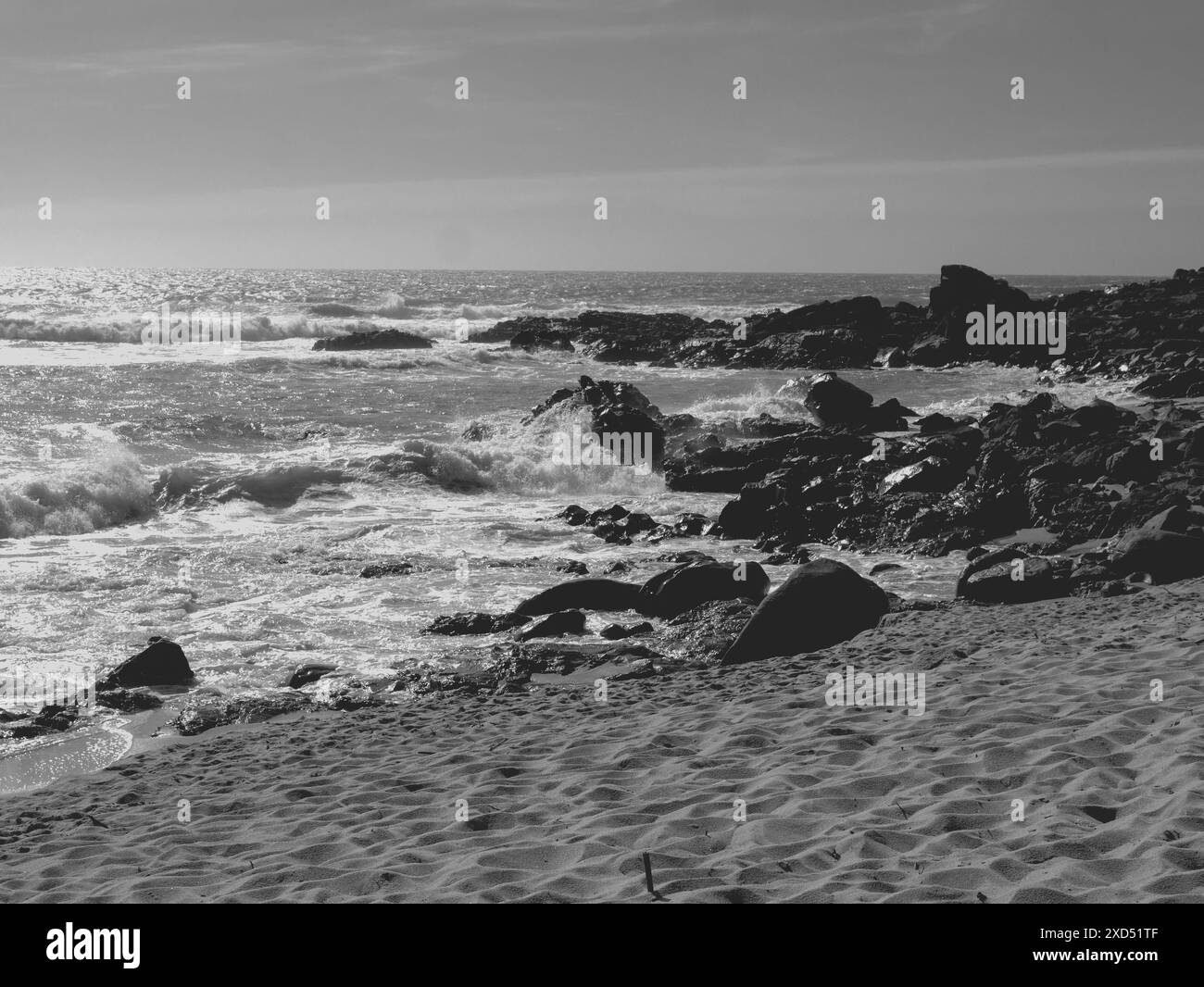 black and white view how Atlantic ocean wave breaks on the big rocky ...