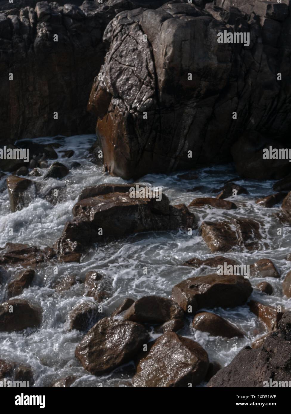 Close up view how Atlantic ocean wave breaks on the big rocky stone ...
