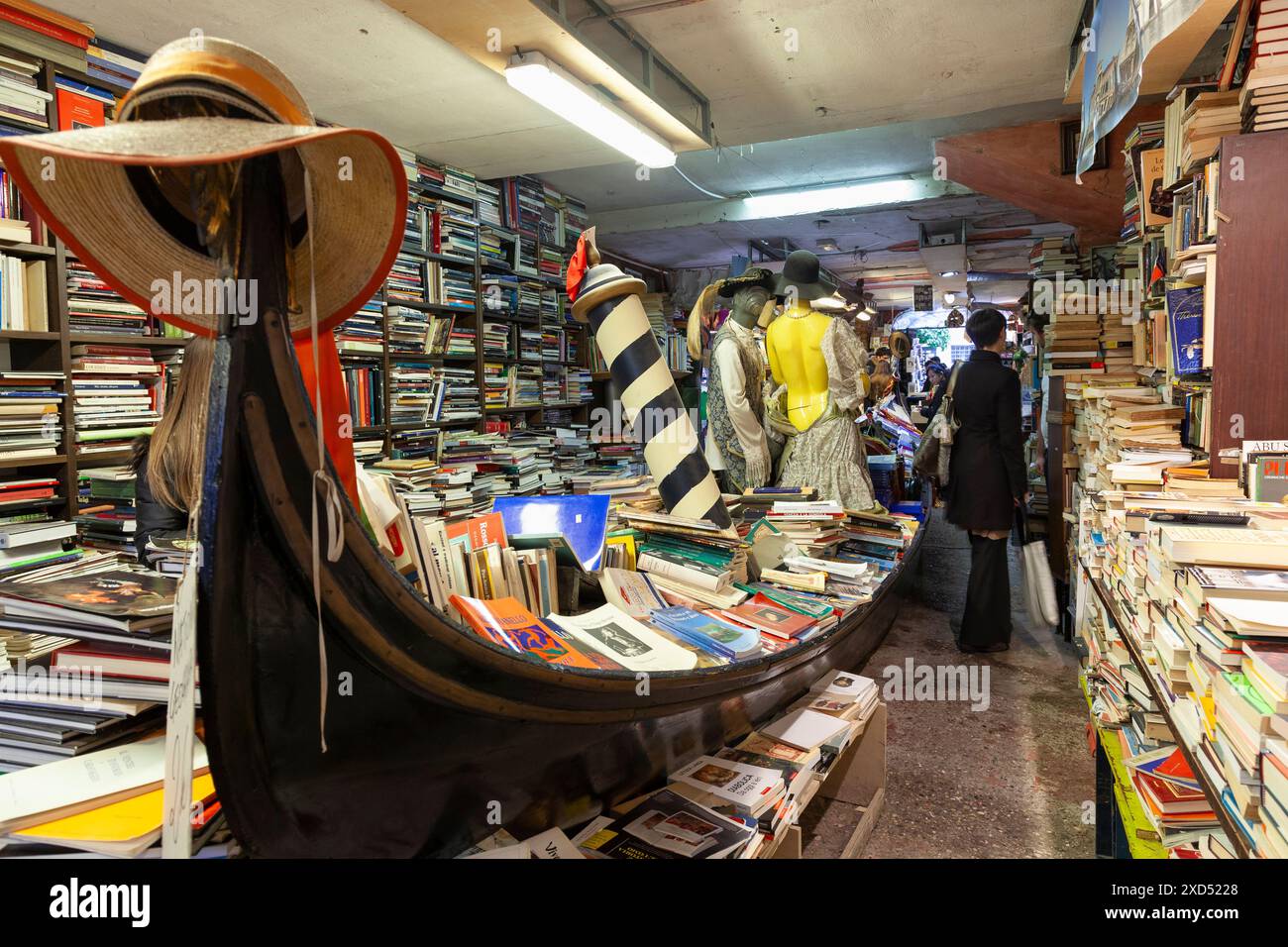 Interior of Libreria Acqua Alta with shoppers, a unique bookstore with ...