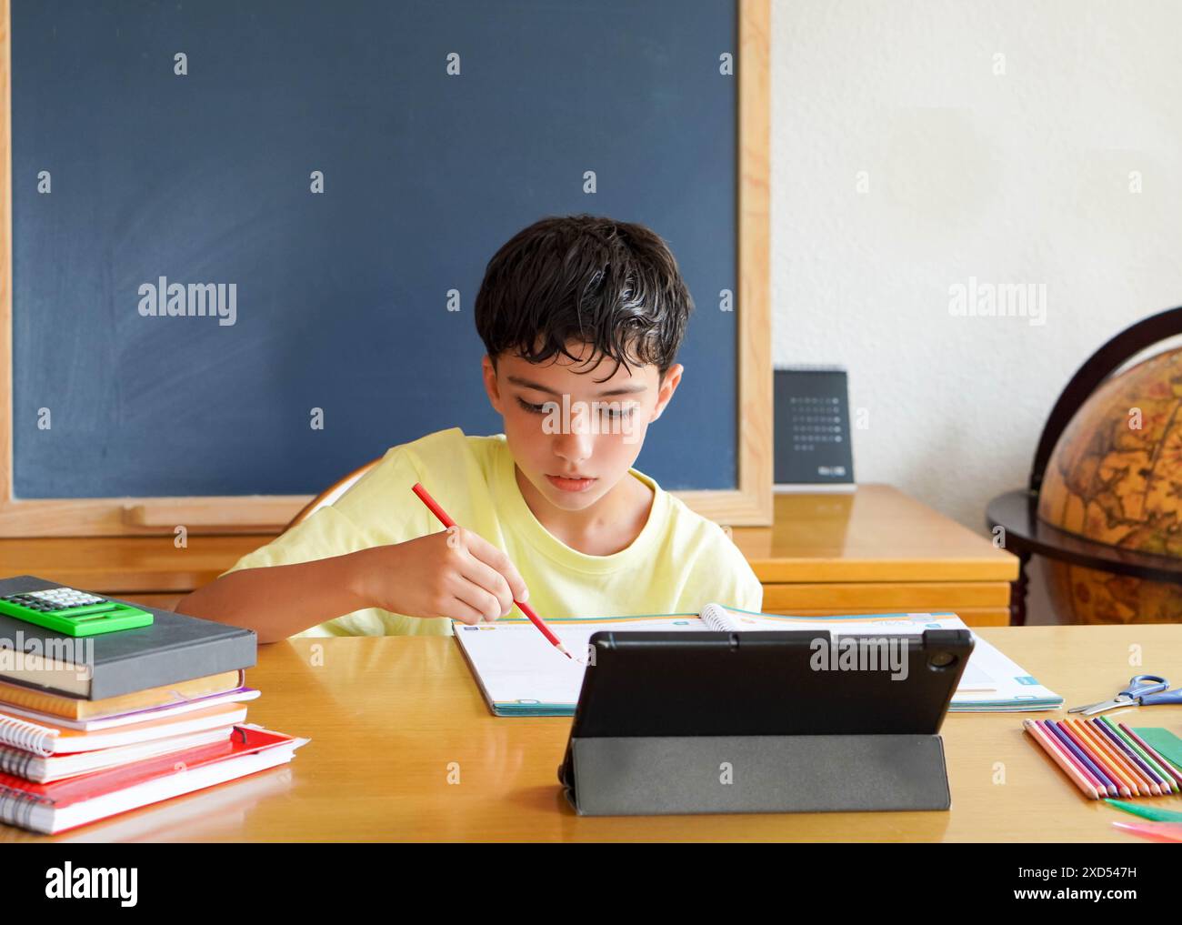 student preteen boy learning with the help of electronic devices. back ...