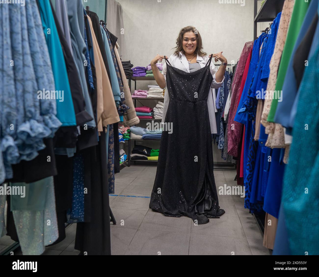 A fat woman chooses clothes in a plus size store Stock Photo - Alamy