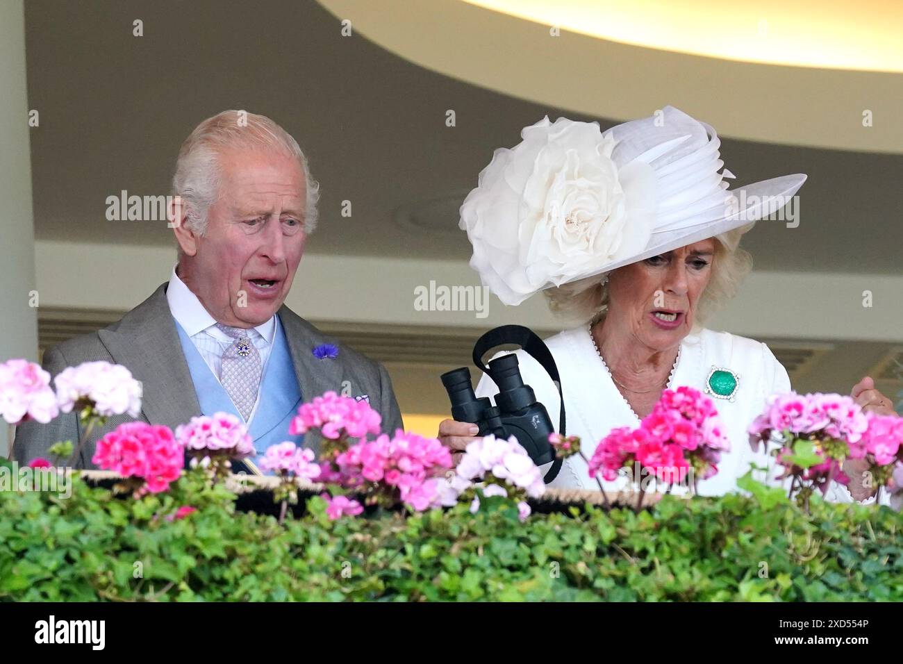 King Charles III (left) and Queen Camilla react during the King George ...