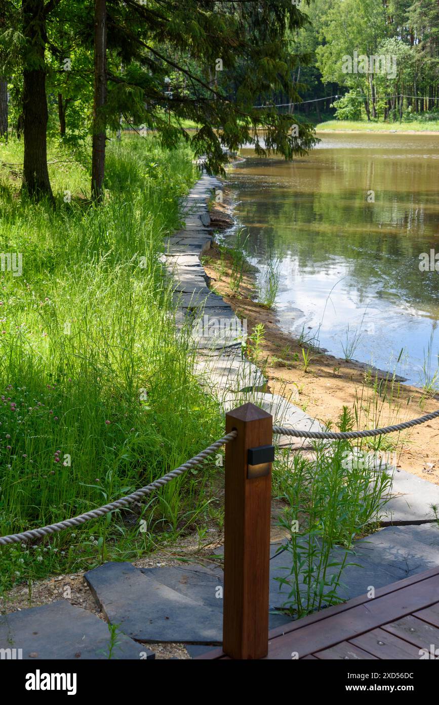 A winding stone path along the lake shore for walks in the park ...