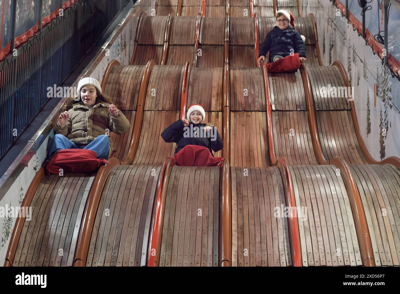 Classic slides in an amusement park. Children have fun sliding down a ...