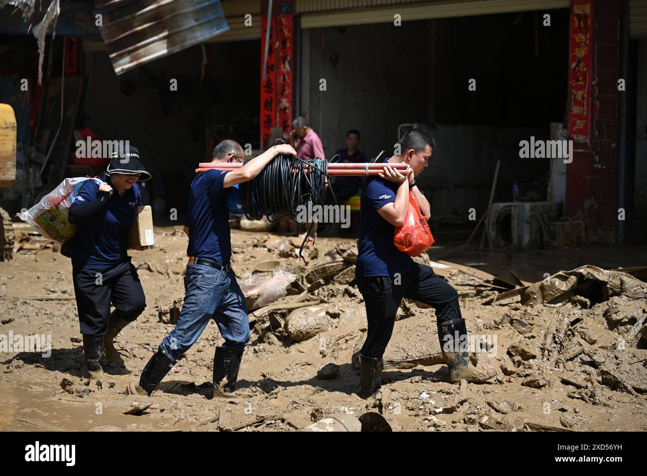 Longyan, China's Fujian Province. 20th June, 2024. Workers carry cable ...