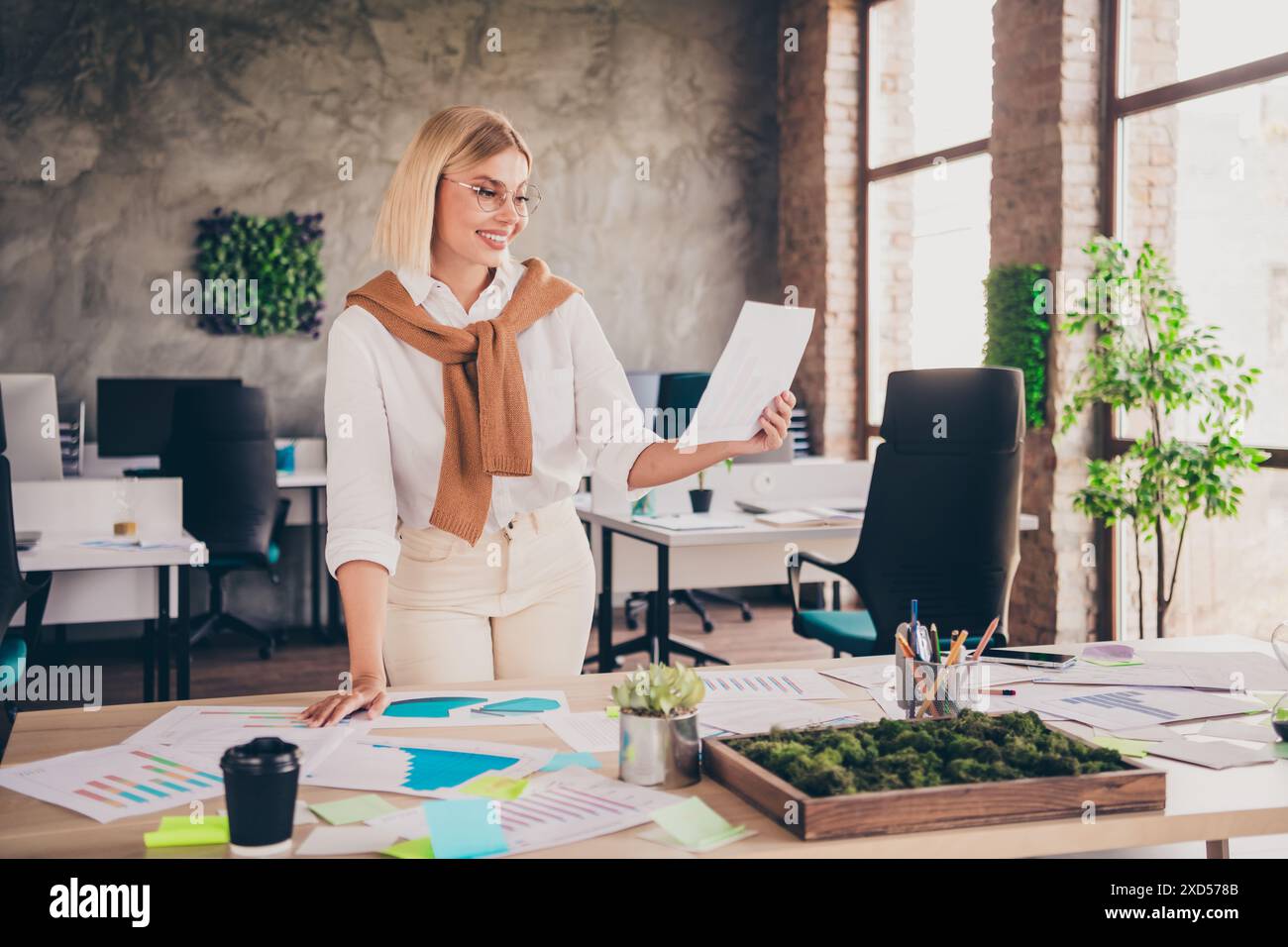 Photo portrait of lovely young lady analyze graph papers dressed ...